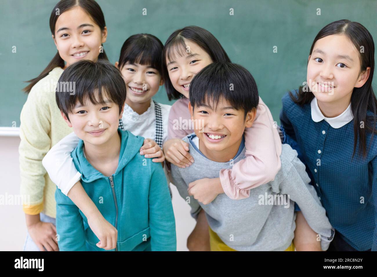 Elementary school students playing in front of the blackboard Stock ...