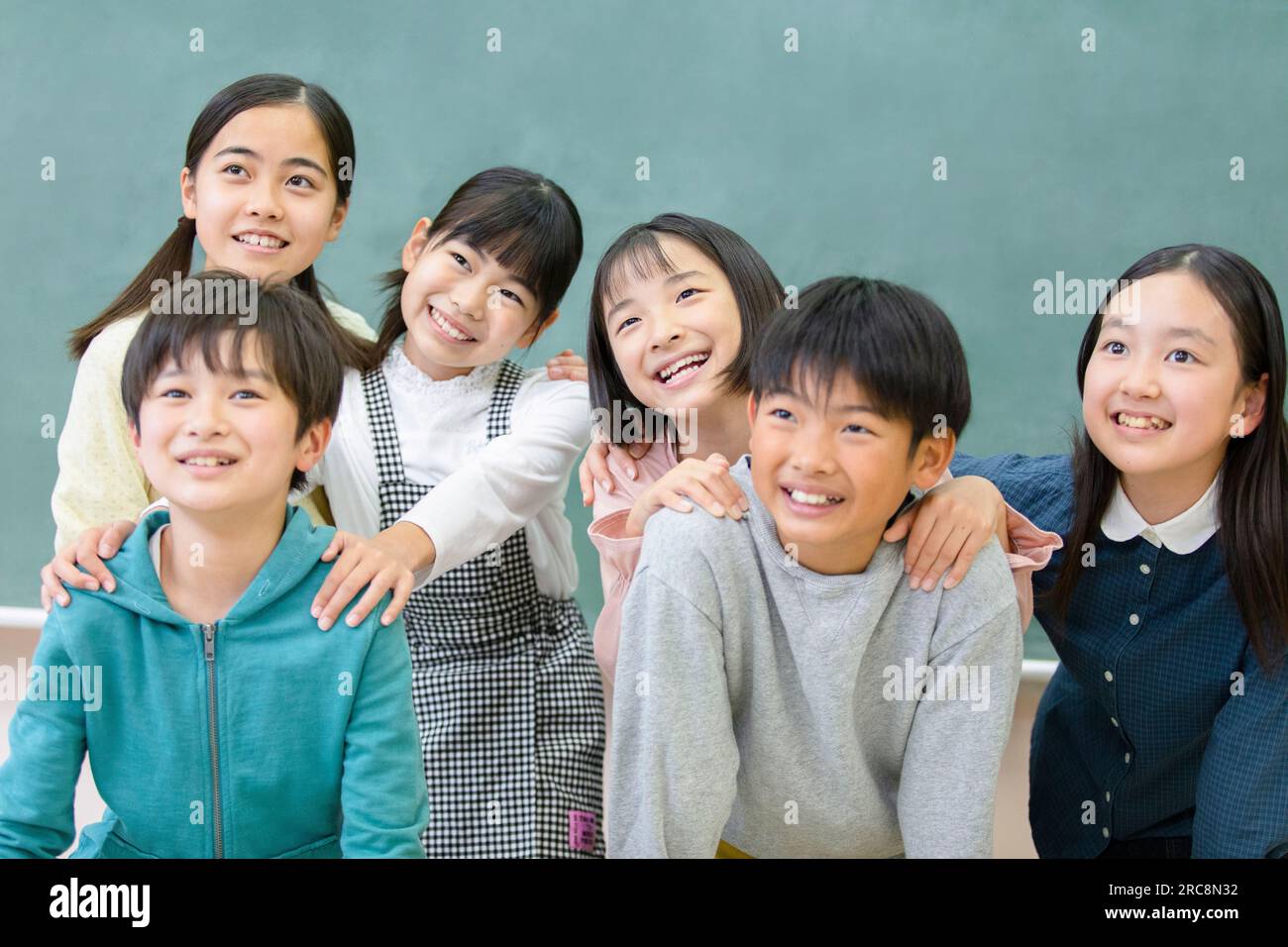 Elementary school children playing in front of the blackboard Stock ...