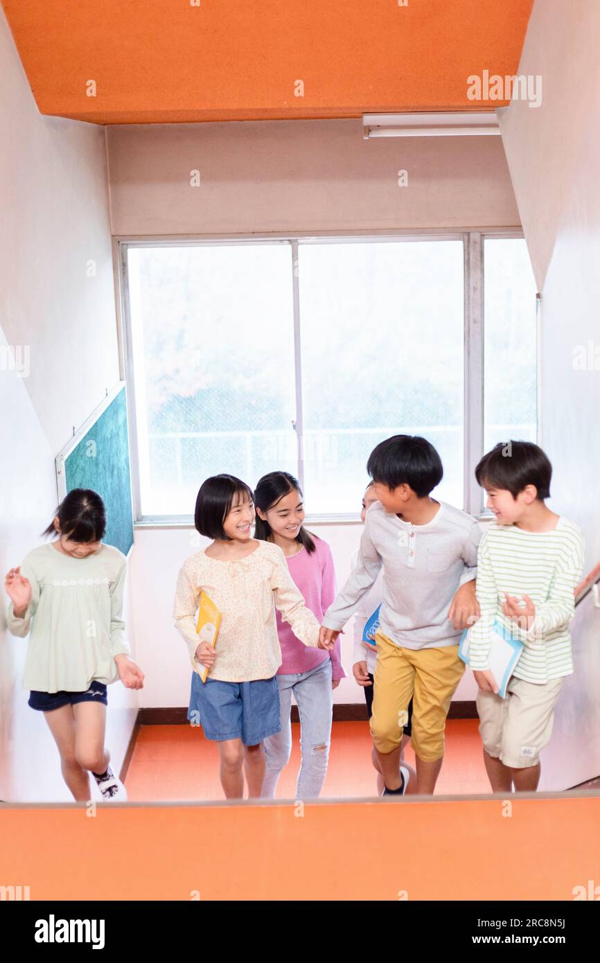Elementary school students walking on the stairs Stock Photo - Alamy