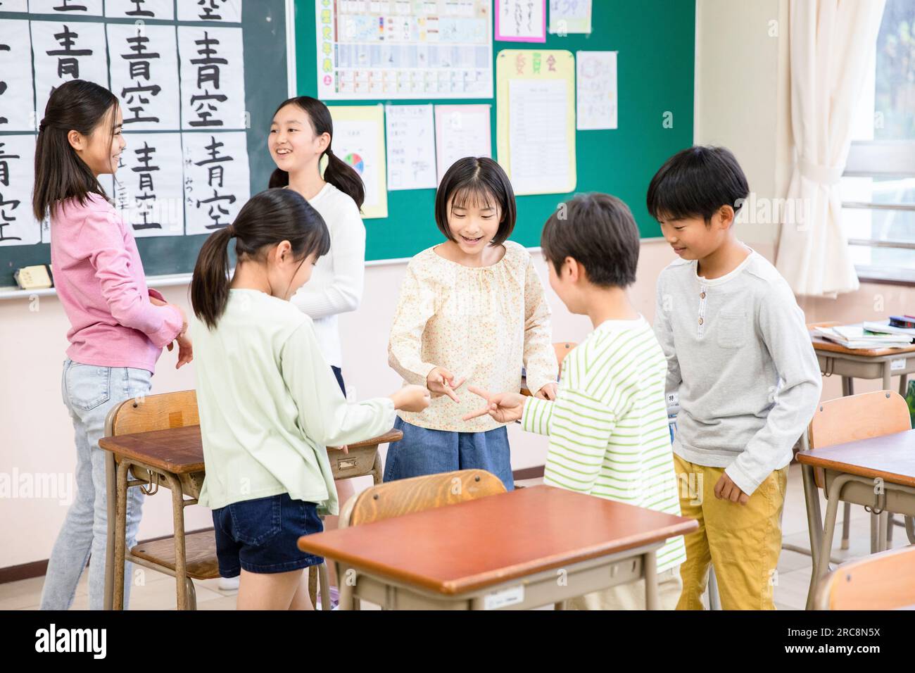 Elementary school students playing in a classroom Stock Photo - Alamy