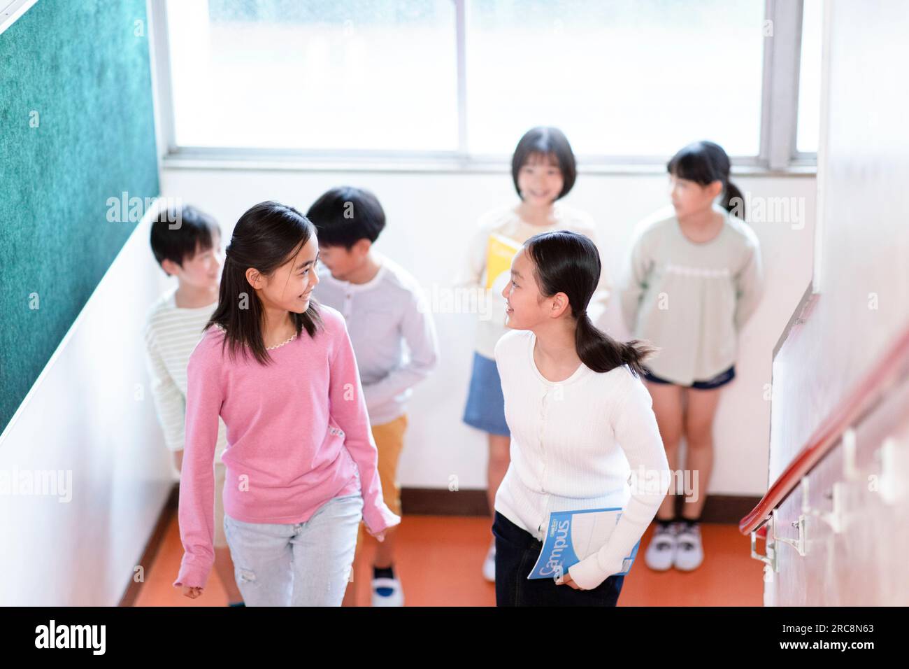 Elementary school students walking down the stairs Stock Photo - Alamy