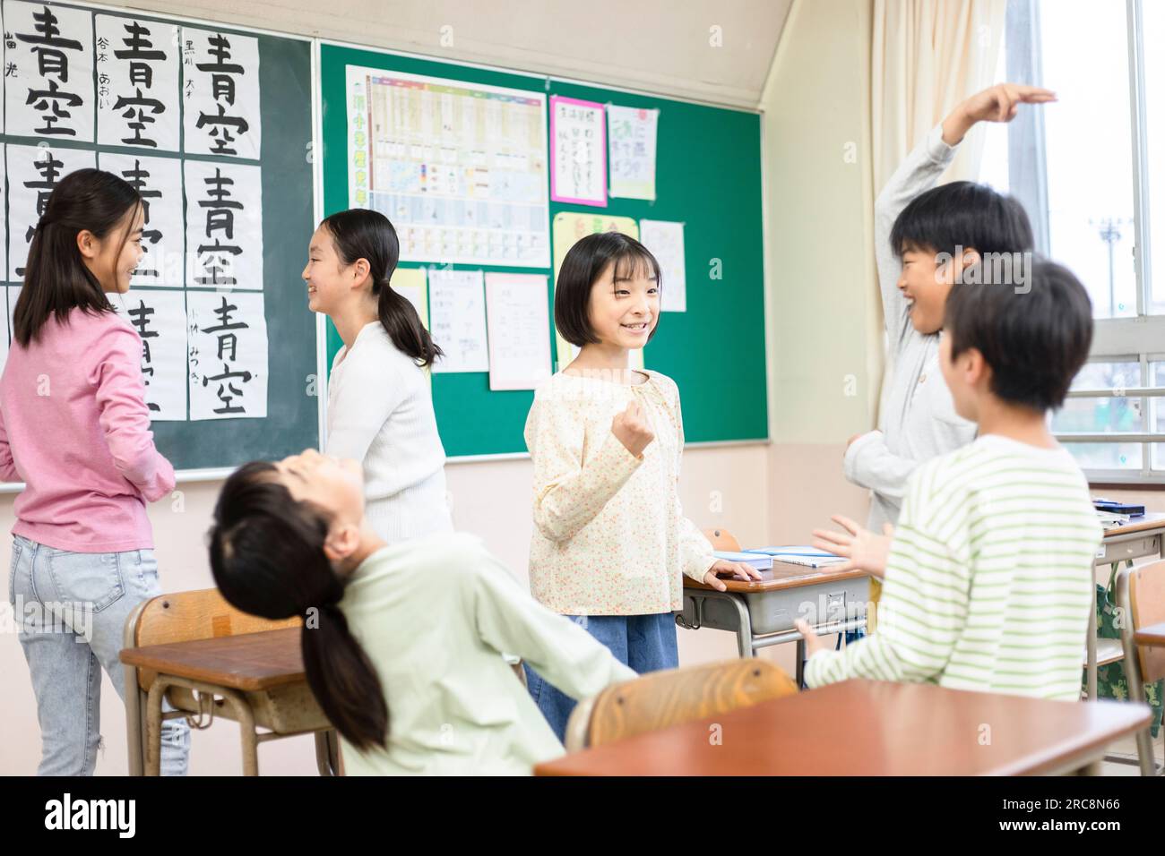 Elementary school students playing in a classroom Stock Photo - Alamy