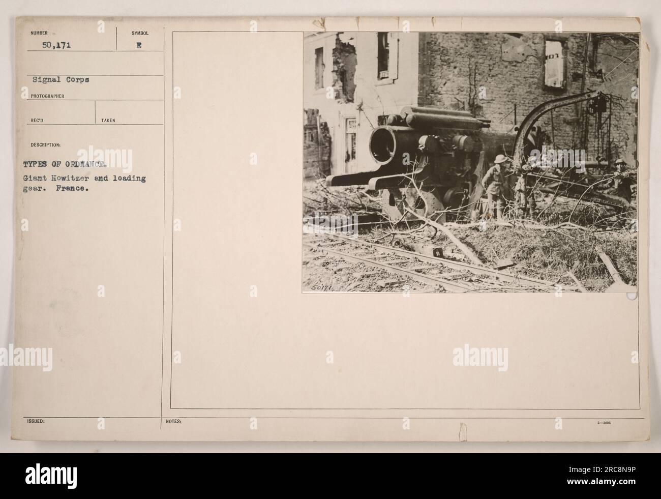 A photograph showing a giant howitzer and its loading gear used during ...