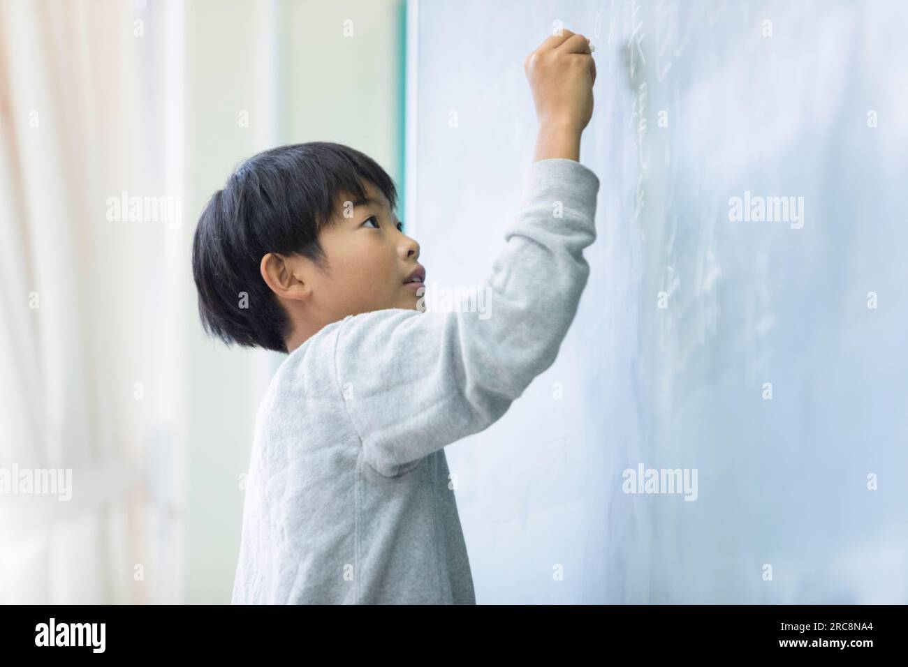 Elementary school students solving problems on the blackboard Stock ...