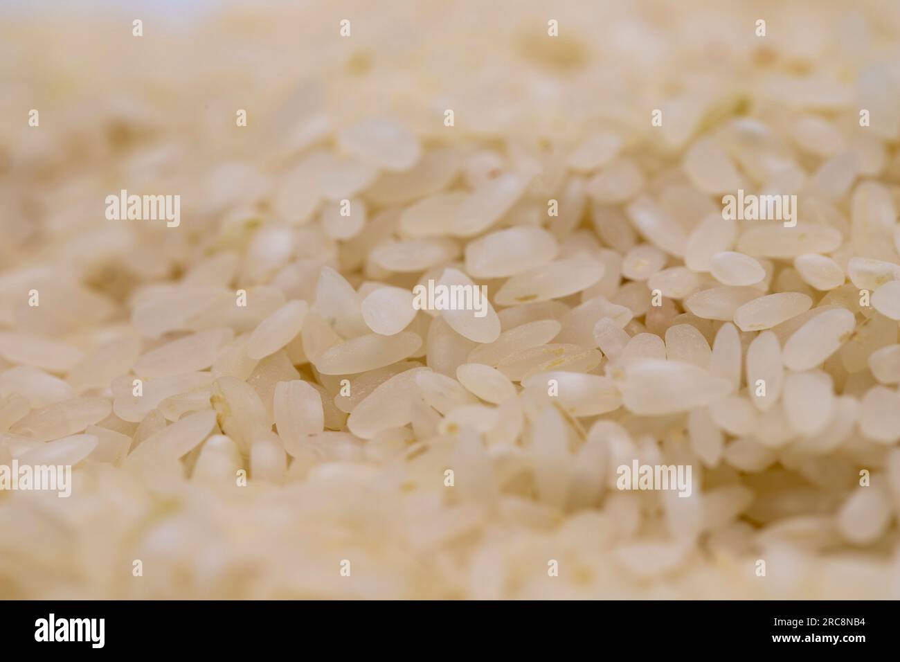 Pile of raw rice as background, legumes as background. close-up of ...