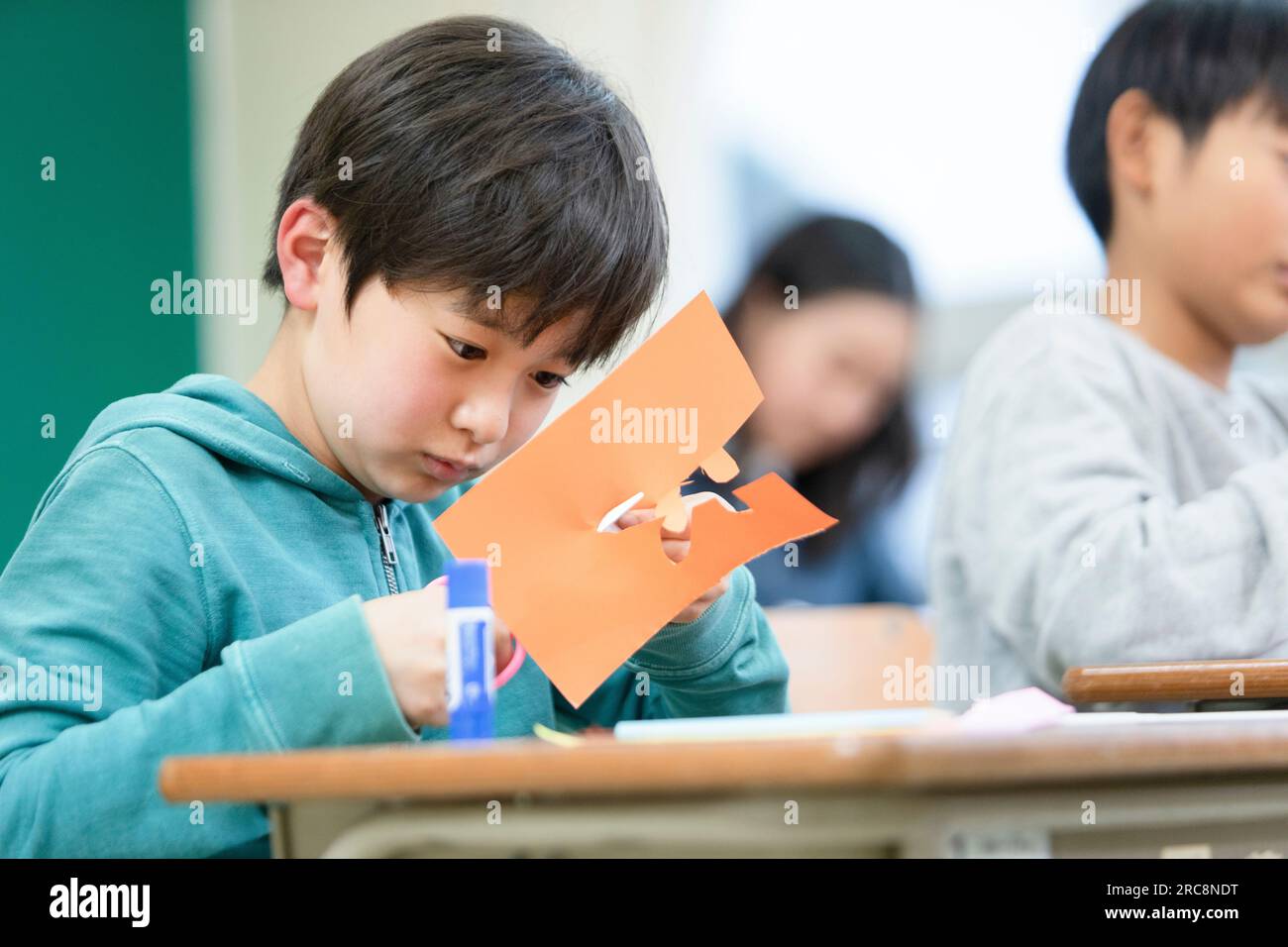 Elementary school students making crafts in the classroom Stock Photo ...