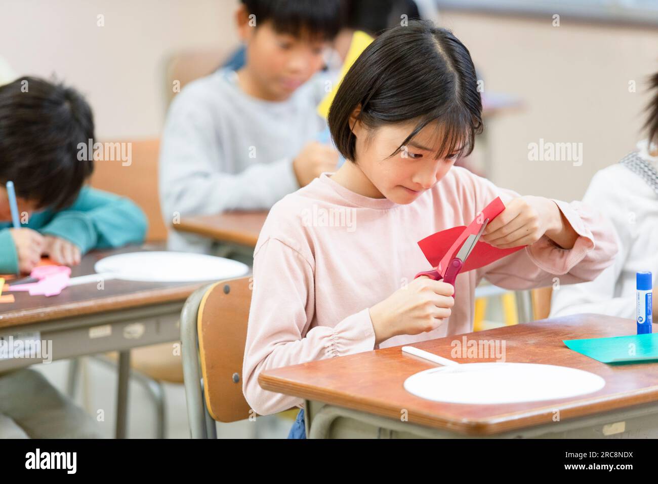 Elementary school students doing crafts in the classroom Stock Photo ...