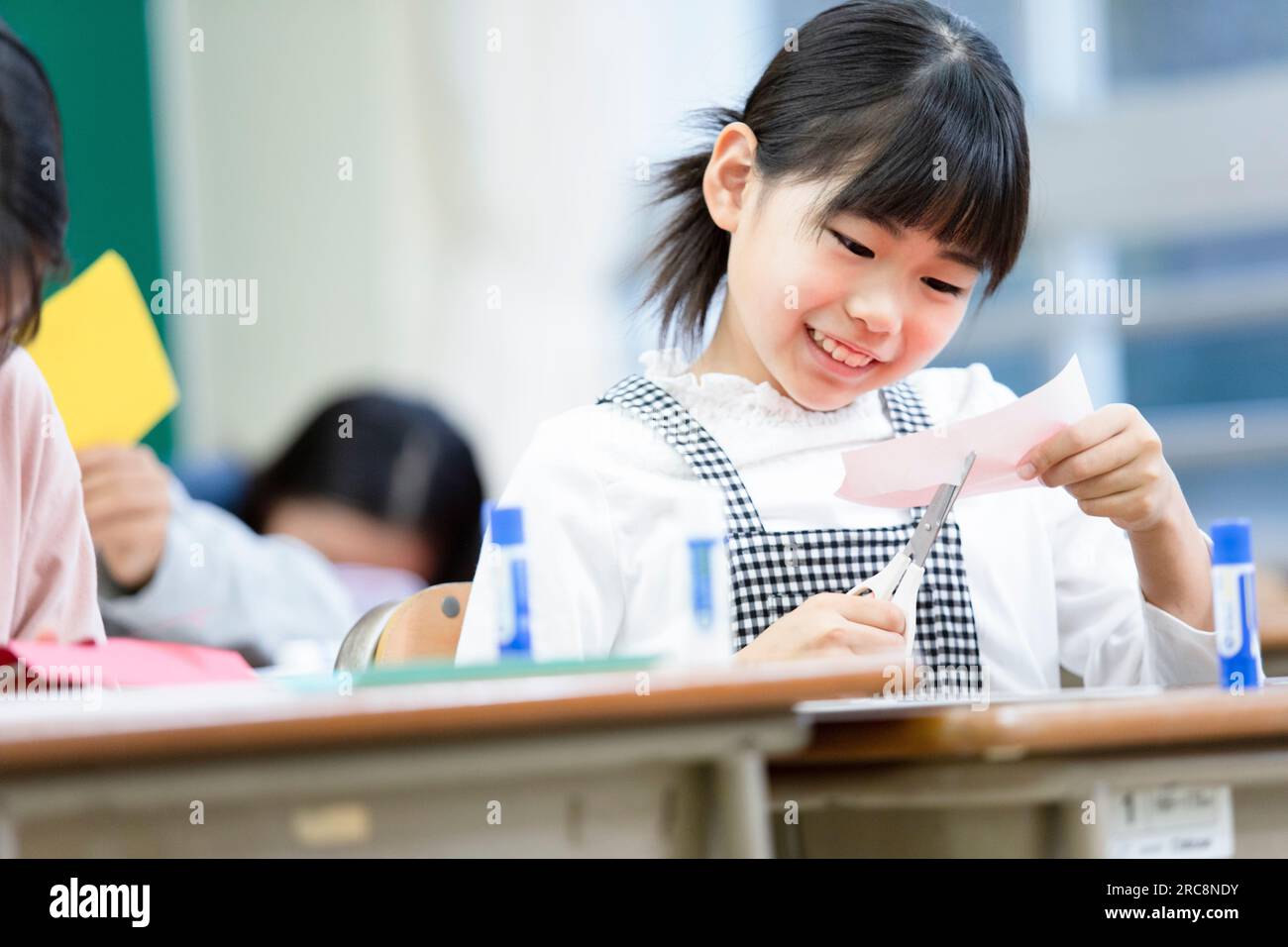 Elementary school students doing crafts in the classroom Stock Photo ...