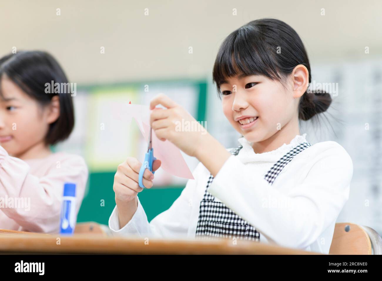 Elementary school students doing crafts in the classroom Stock Photo ...