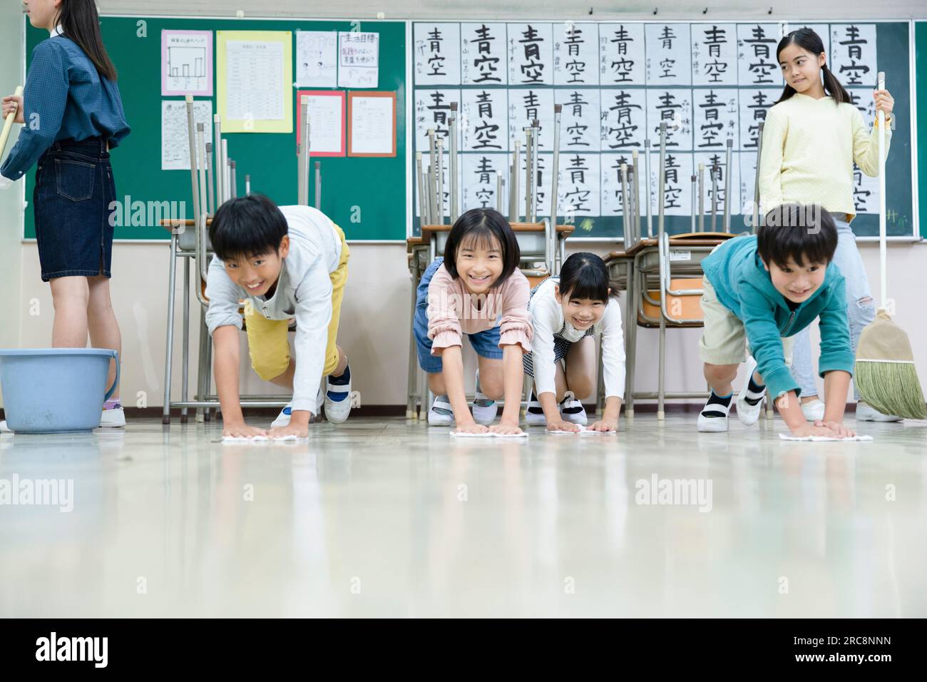 Elementary school students dusting the classroom floor Stock Photo - Alamy