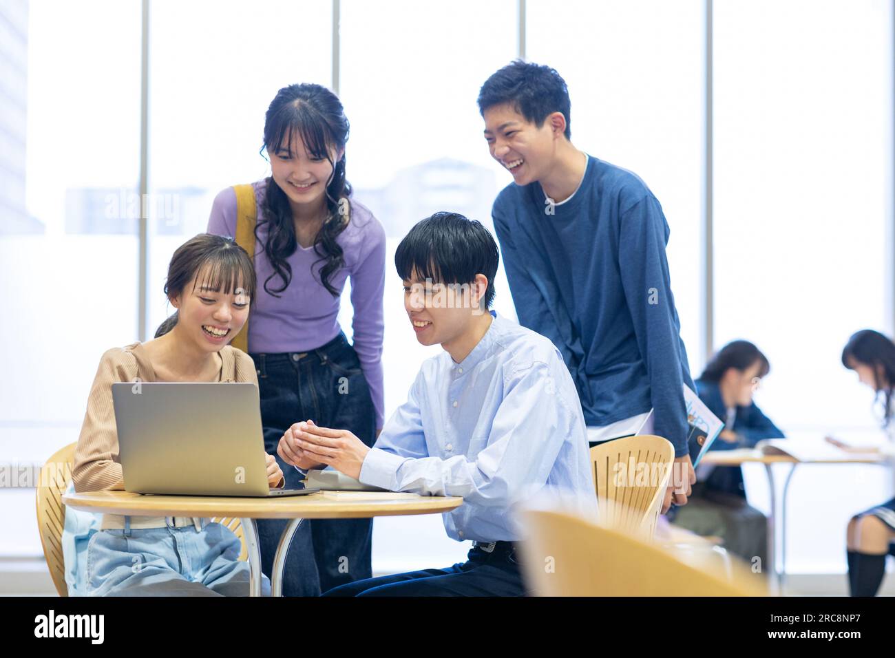 Students looking at a computer Stock Photo - Alamy
