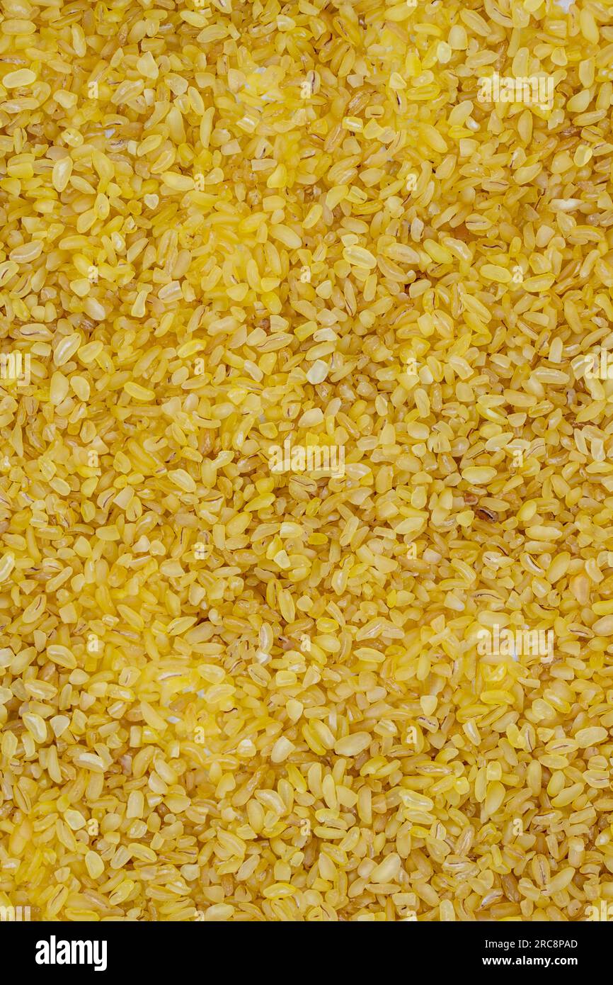 Pile of raw bulgur wheat as background, legumes as background. close-up ...