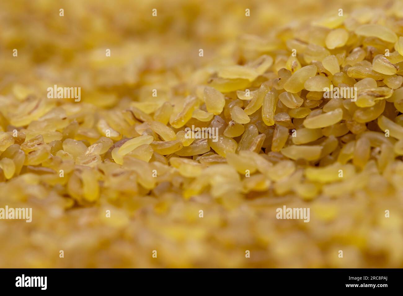 Pile of raw bulgur wheat as background, legumes as background. close-up ...