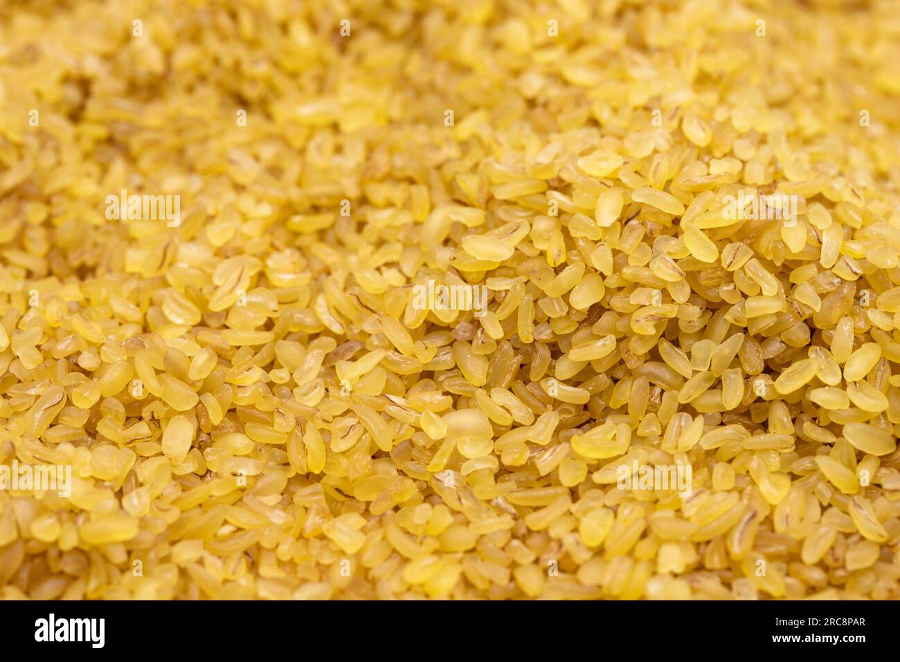 Pile of raw bulgur wheat as background, legumes as background. close-up ...