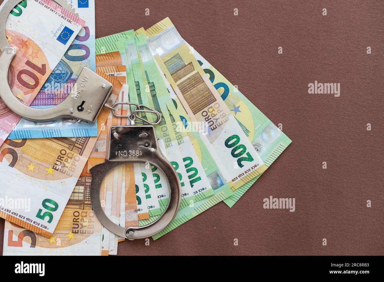 economic crimes.Handcuffs on euro bills background.Arrest on bank ...