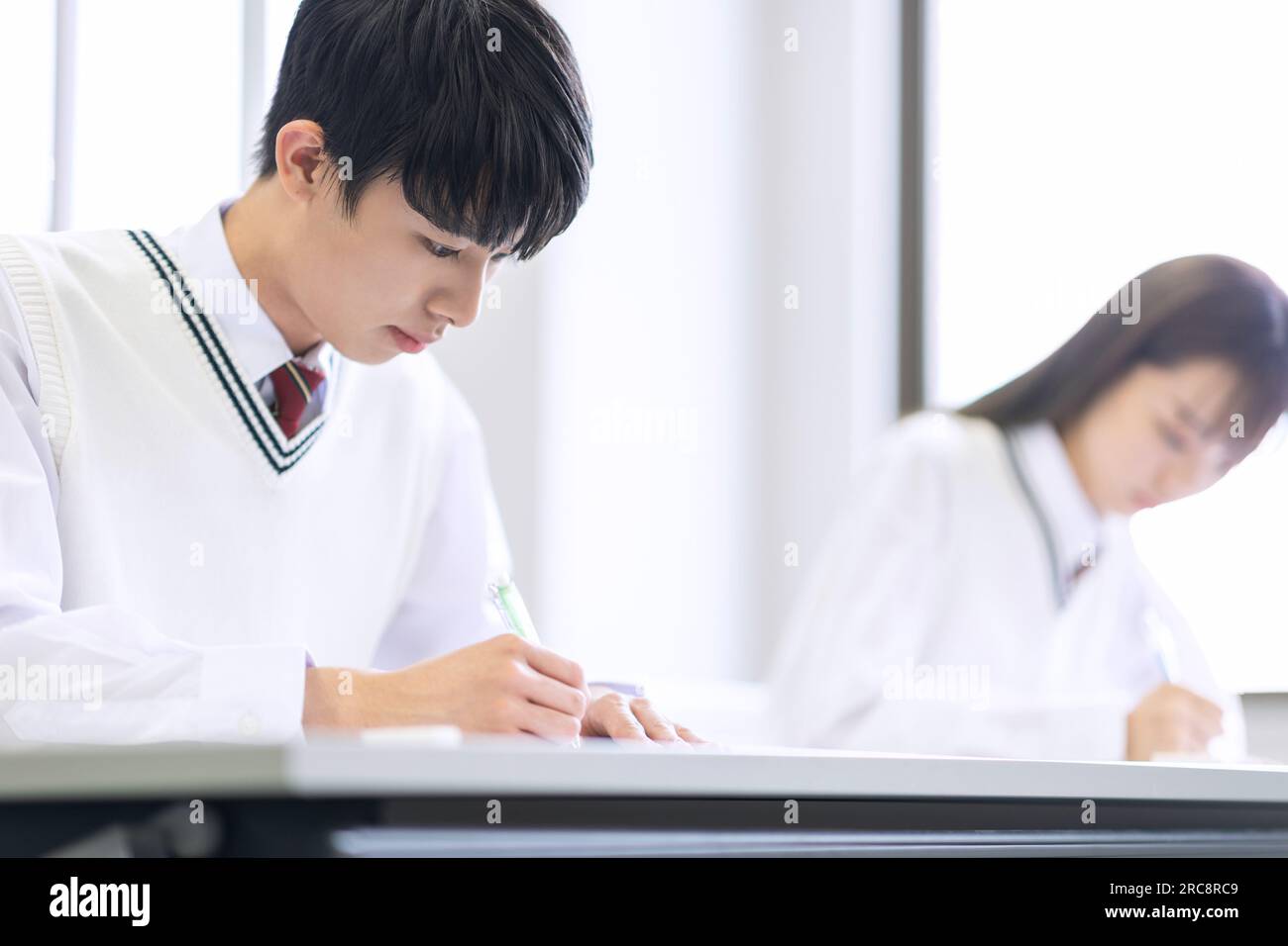 Students taking exam uniform hi-res stock photography and images - Alamy
