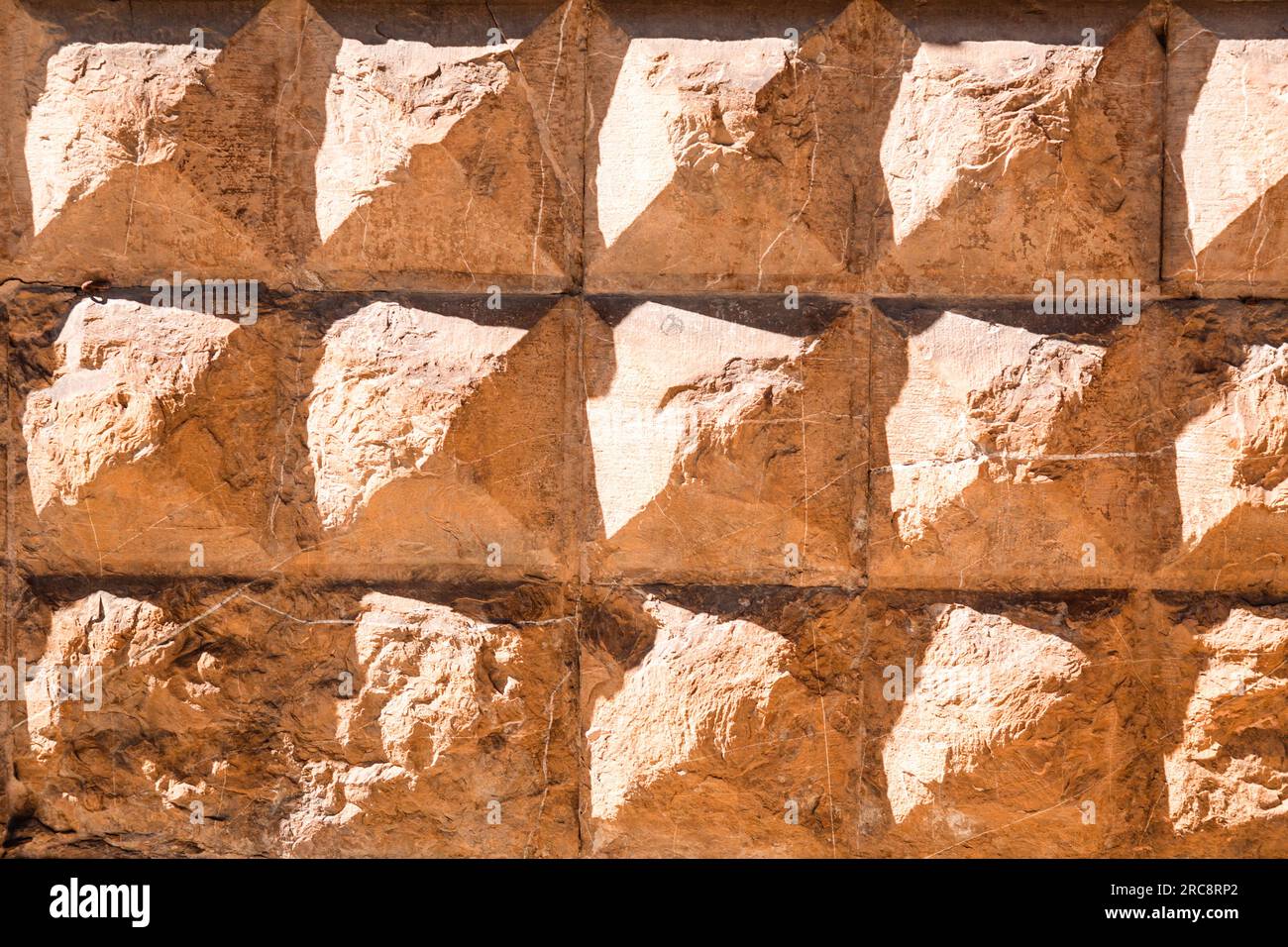 Textured fragment of the granite peaks covering a wall in Florence ...