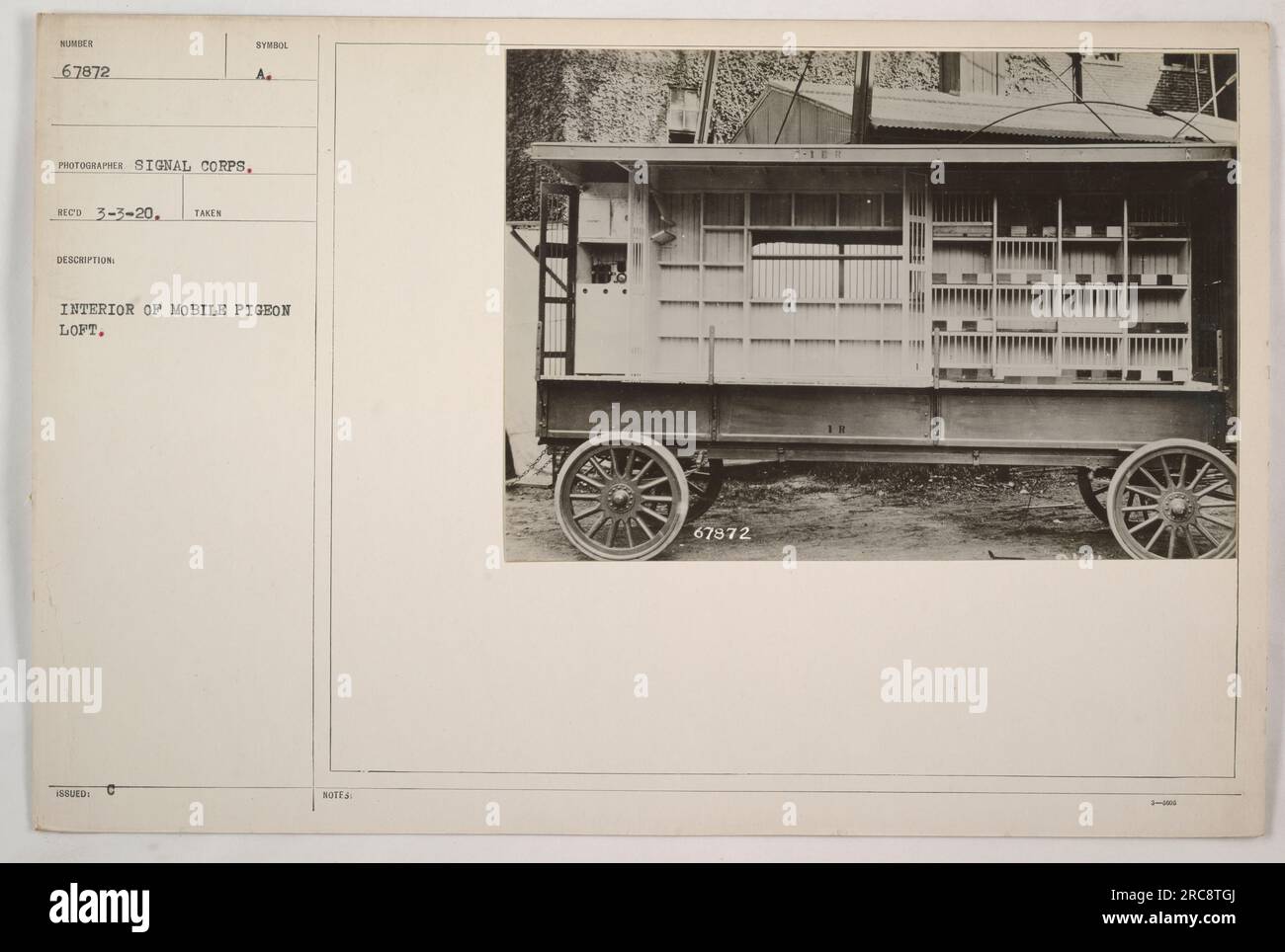 The photograph shows the interior of a mobile pigeon loft, identified ...