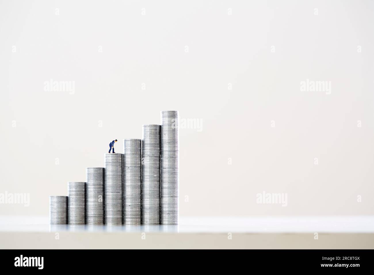 Stack of one yen coins and miniature people Stock Photo - Alamy