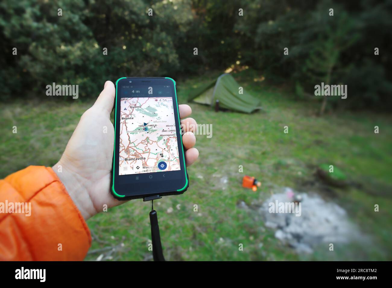 phone in hand displays position/destination marker on trail map osm for ...