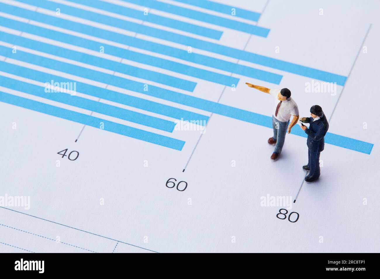 People in miniature with graphs Stock Photo - Alamy