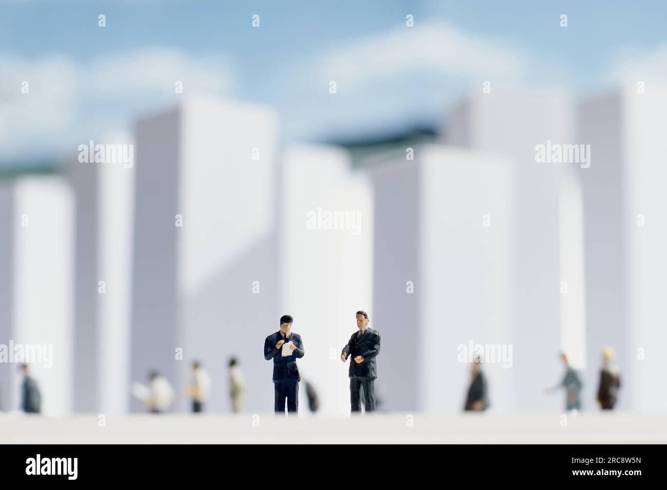 Group of buildings and miniature office workers Stock Photo - Alamy