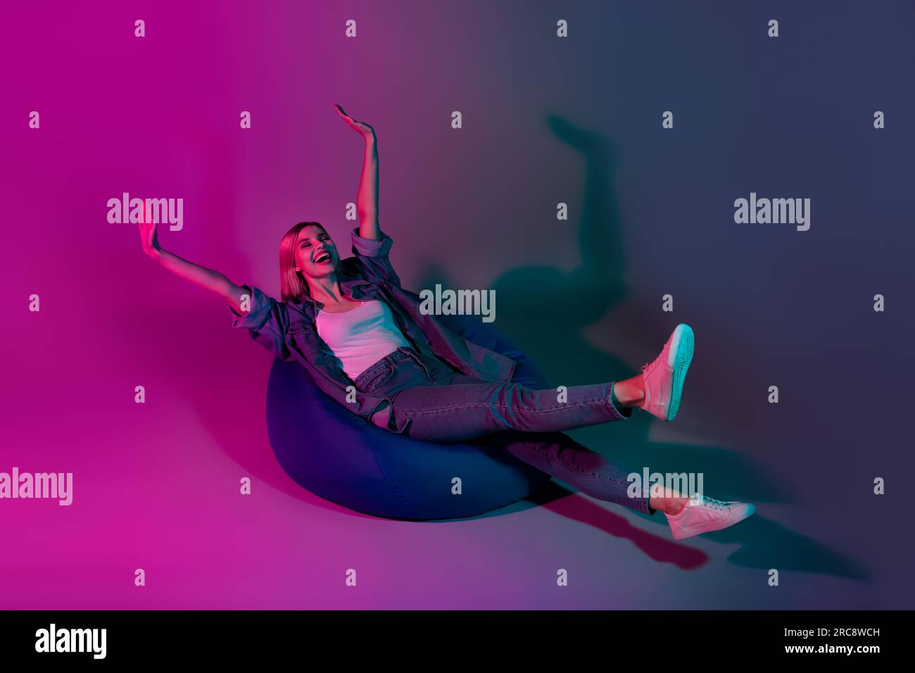 Photo of positive cheerful lady rest relax imagine ride on armchair ...