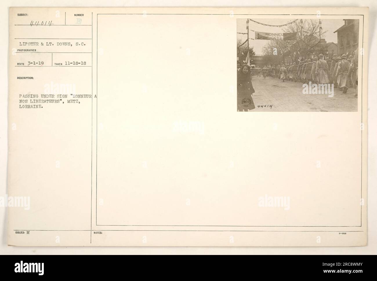 Soldiers Lipster and Lt. Downs seen passing under a sign that reads ...