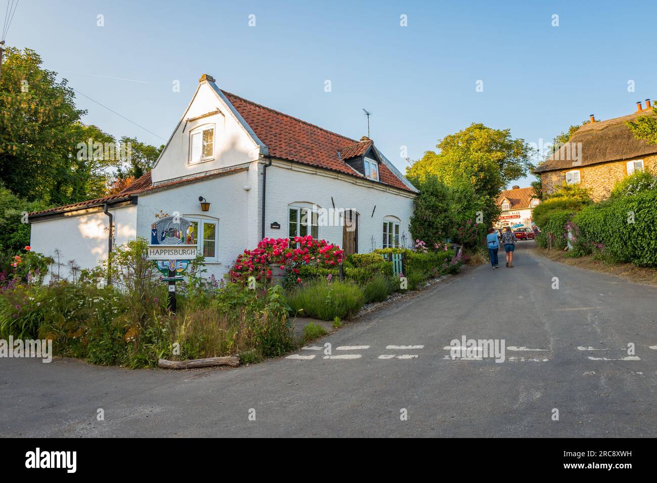 The Norfolk coastal village of Happisburgh with village sign and white ...