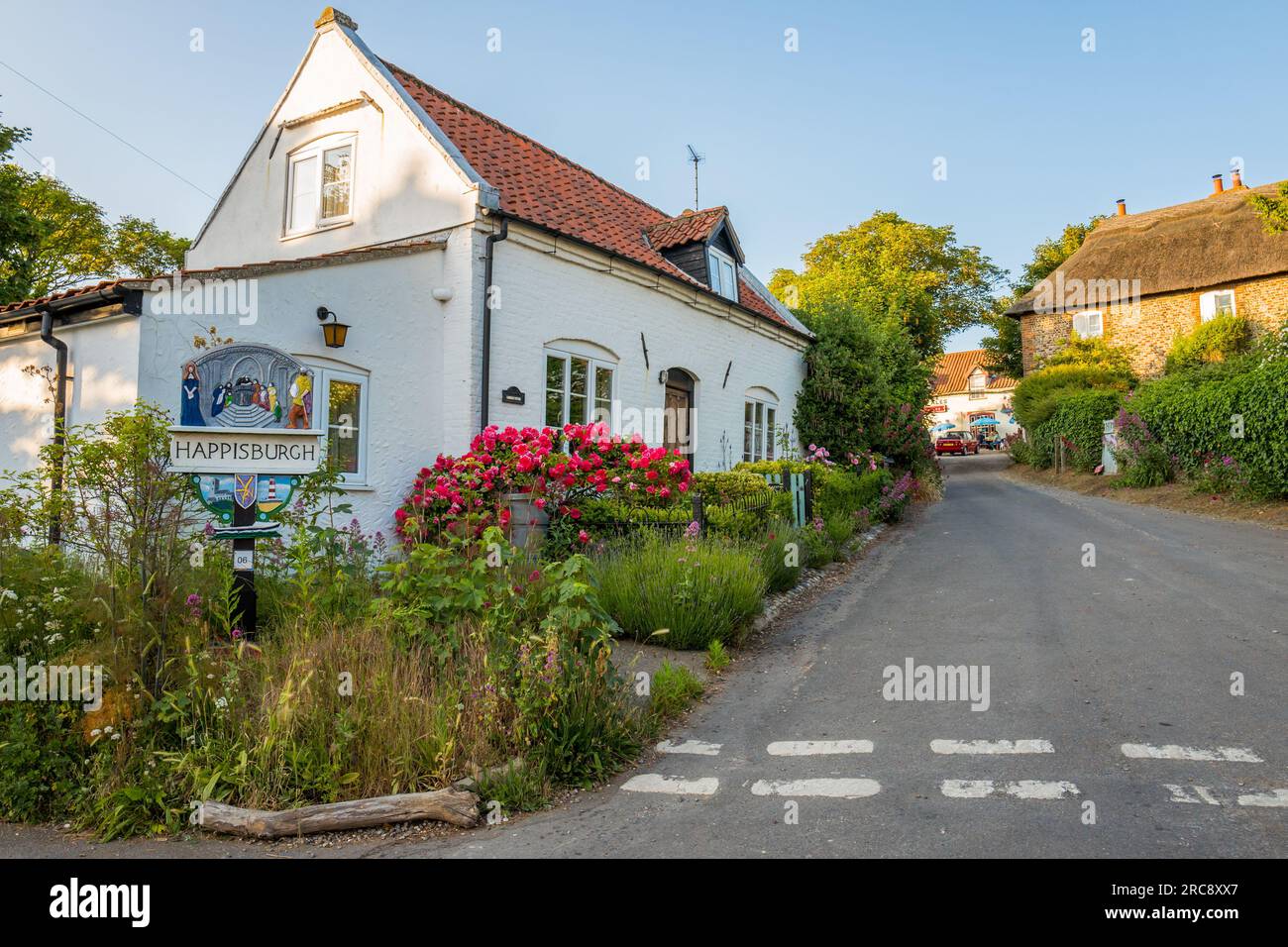 The Norfolk coastal village of Happisburgh with village sign and white ...