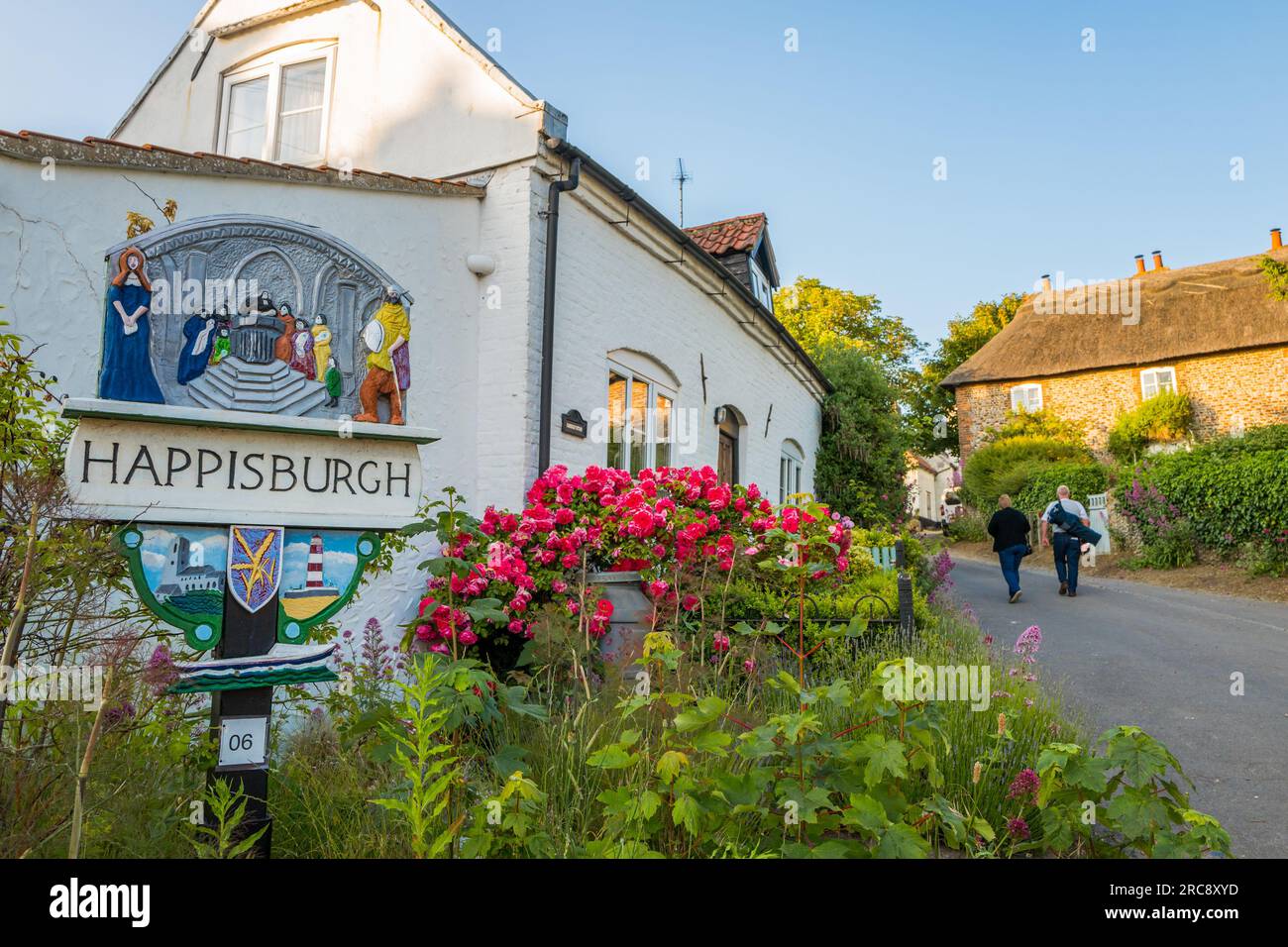 The Norfolk coastal village of Happisburgh with village sign and white ...
