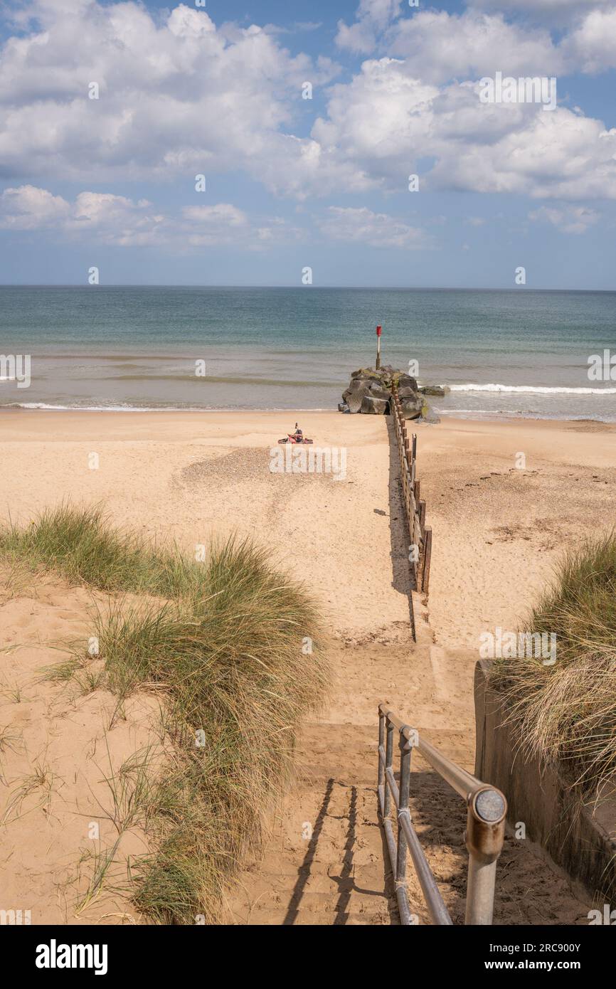 Adults enjoying the hot weather on the sandy beach at Horsey Beach ...