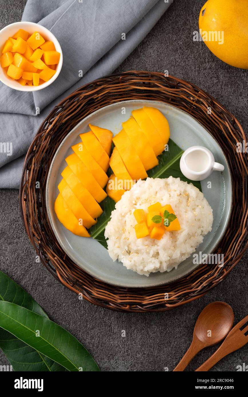 Delicious Thai mango sticky rice with cut fresh mango fruit in a plate ...
