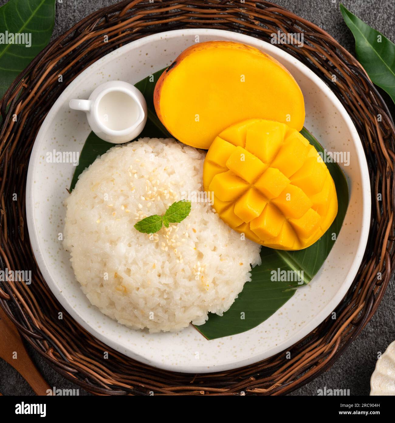 Delicious Thai mango sticky rice with cut fresh mango fruit in a plate ...