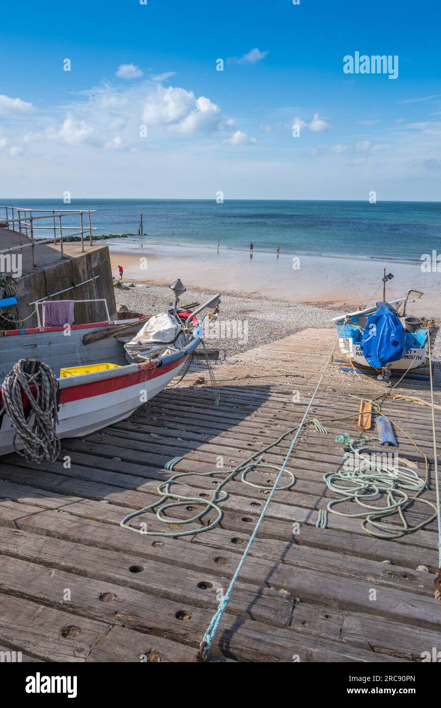 Small fishing boats moored up on the concrete and wooden ramp at ...