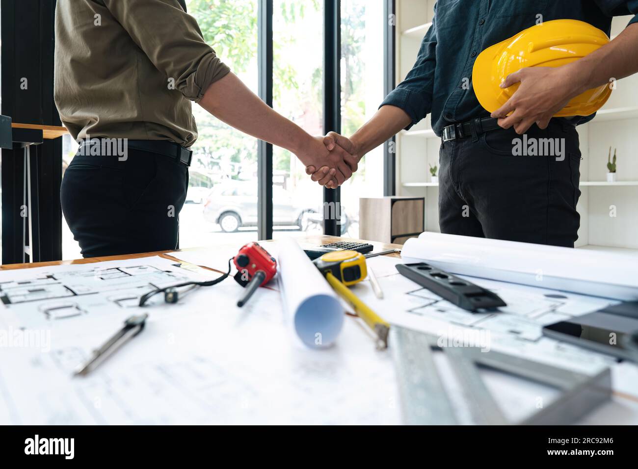 Engineer and contractor shaking hands success of the project work ...