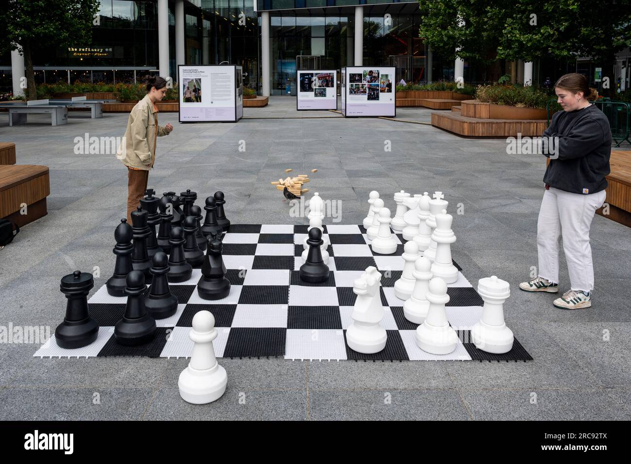 London, UK. 13 July 2023. Women playing giant outdoor chess in Euston ...