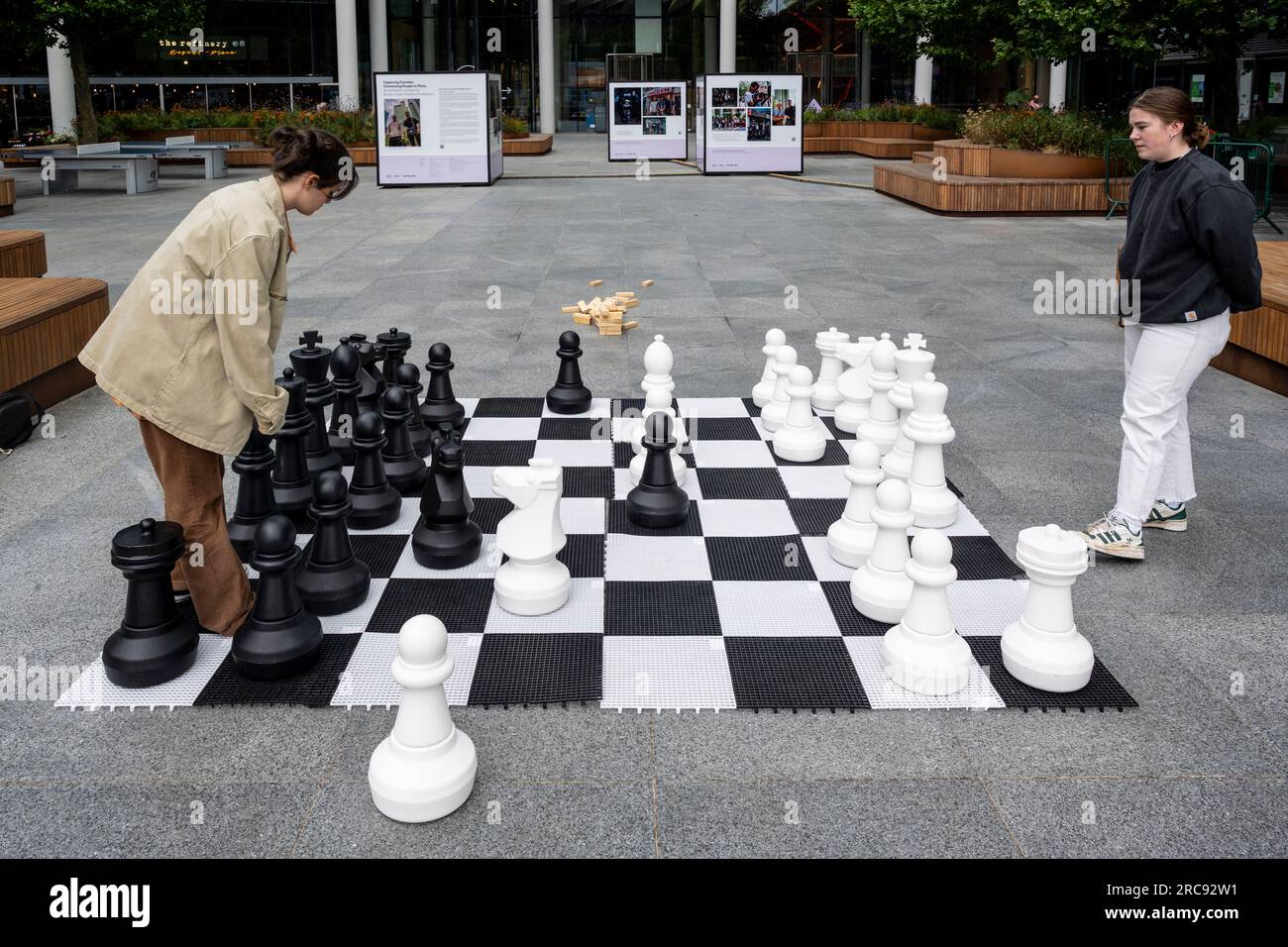 London, UK. 13 July 2023. Women playing giant outdoor chess in Euston ...