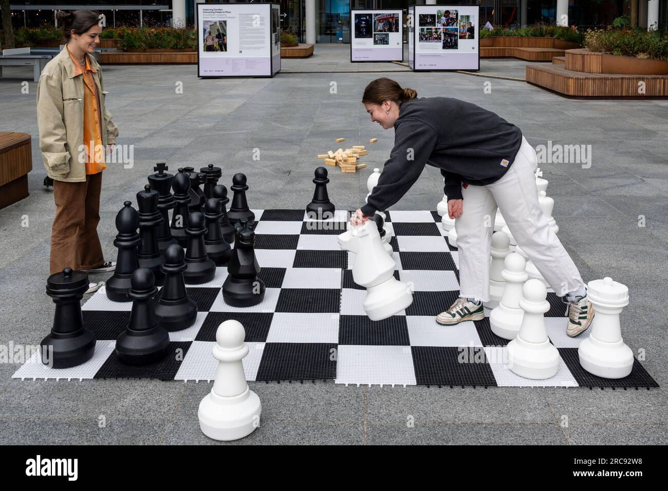 London, UK. 13 July 2023. Women playing giant outdoor chess in Euston ...
