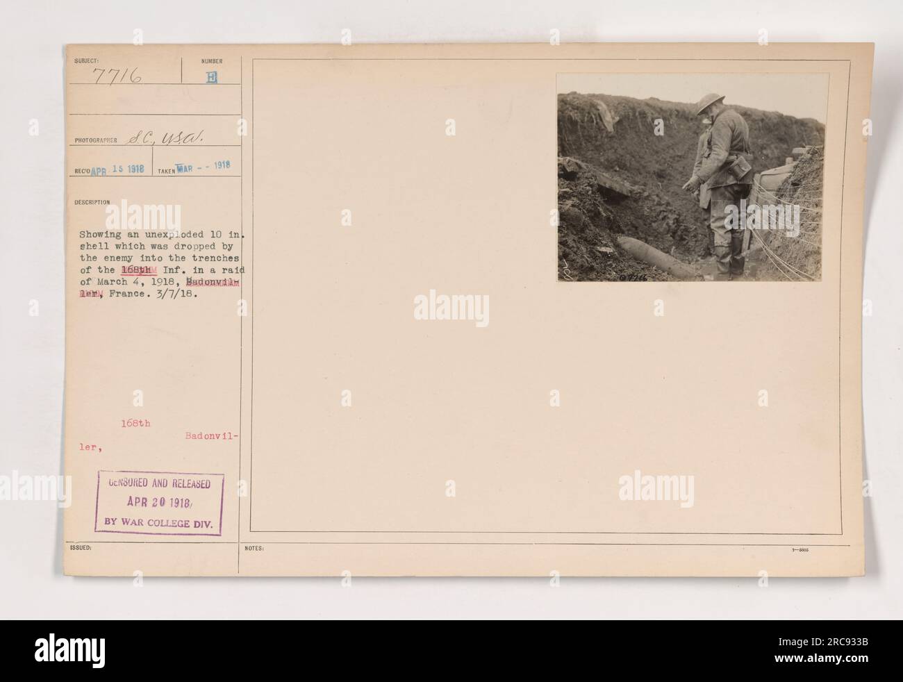 German soldiers are seen examining an unexploded 10-inch shell that was ...