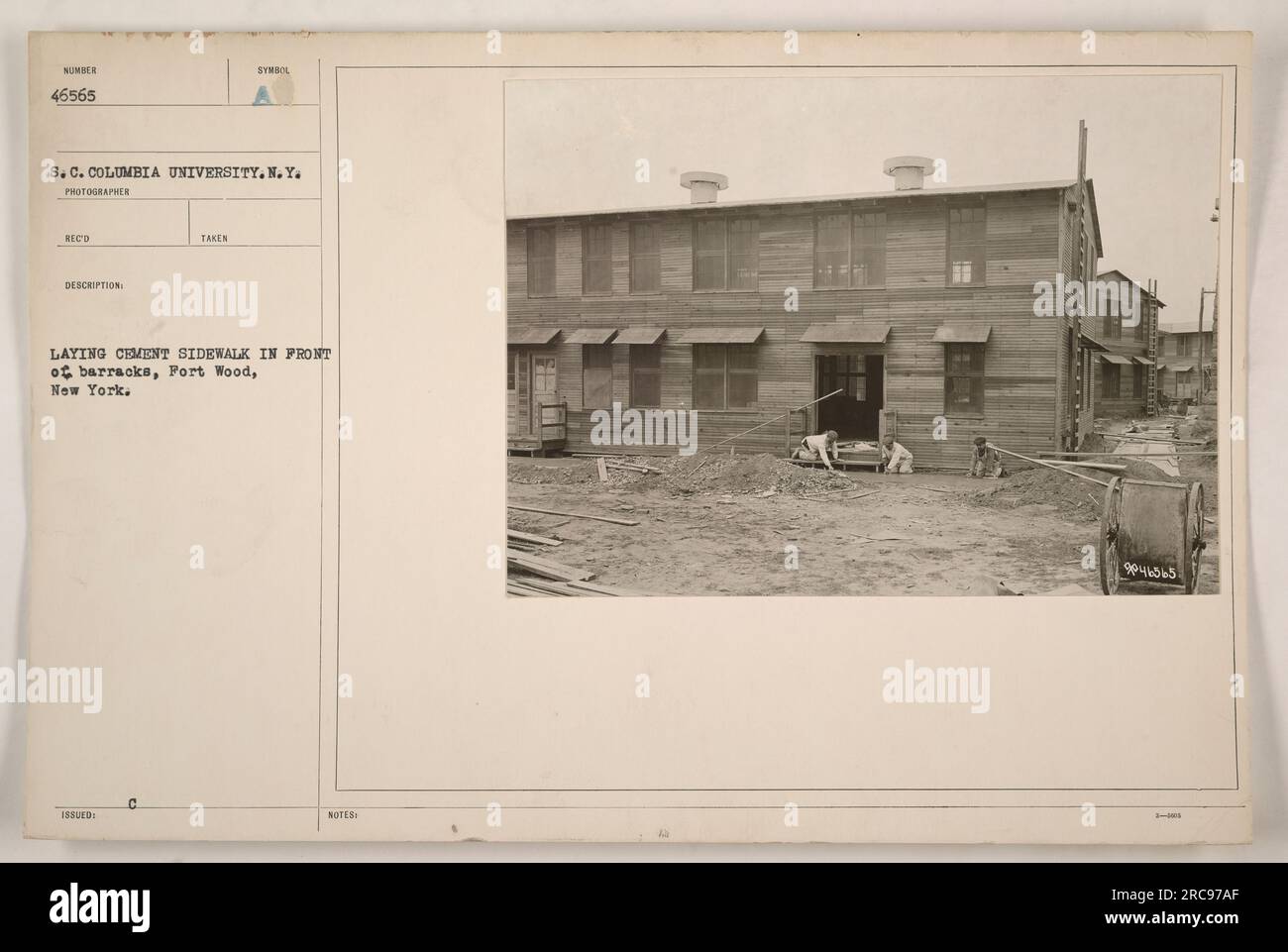 Soldiers at Fort Wood, New York, lay cement sidewalk in front of ...