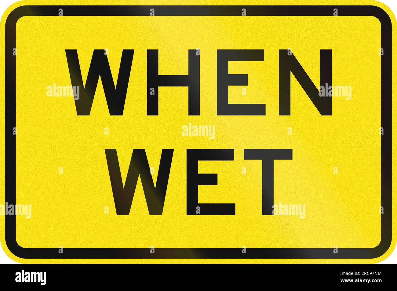 An Australian warning traffic sign - When wet Stock Photo - Alamy