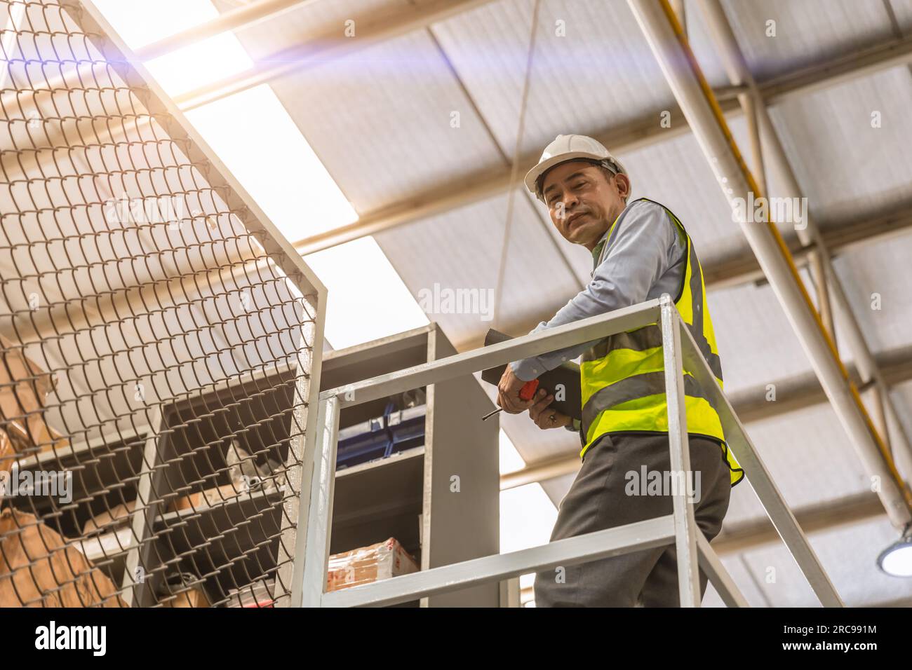 smart senior adult asian engineer male staff worker standing at high ...