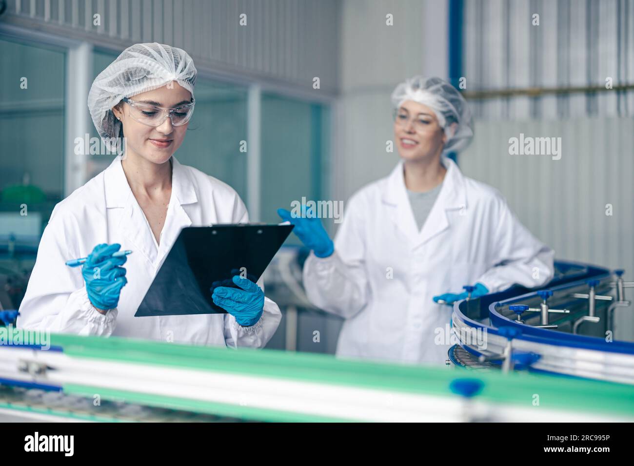 products control quality check team in conveyor belt production line in ...