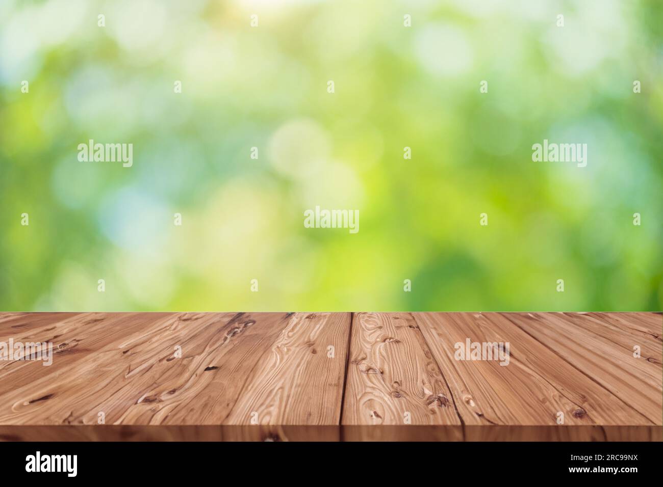 Green blur eco nature with graphic wood table blank space foreground ...