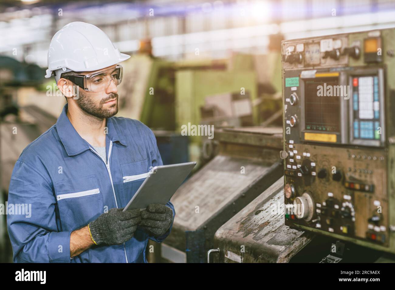Hispanic latin indian male worker working control operate lathe CNC ...