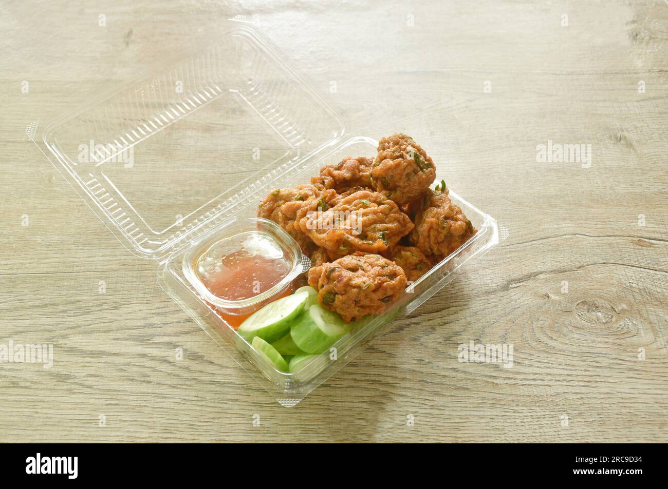 deep fried fish patty with slice cucumber dipping sweet chili sauce in ...