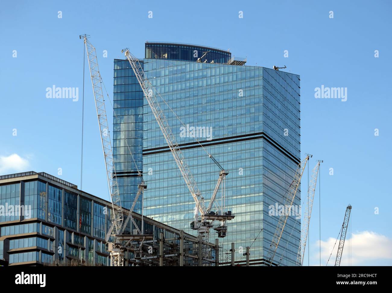 Yellow hoisting tower cranes in construction process of constructing ...