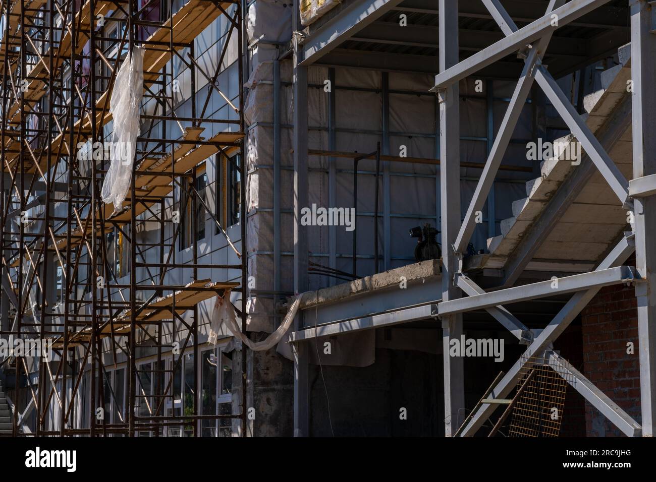 Construction of a building using scaffolding. Facade restoration work ...