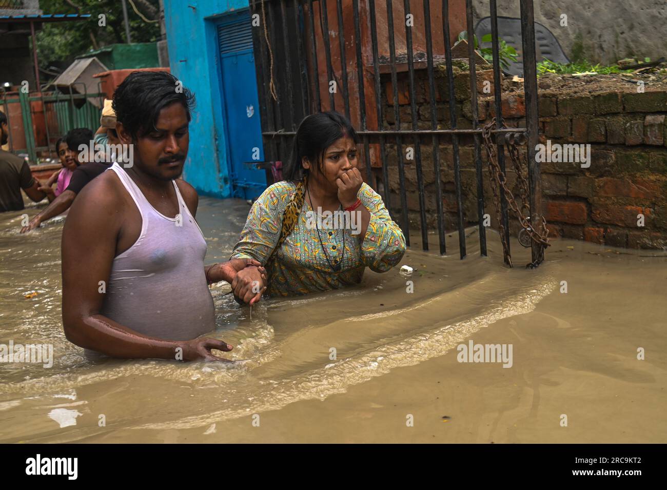 New Delhi, Delhi, India. 13th July, 2023. People wade through a flooded ...